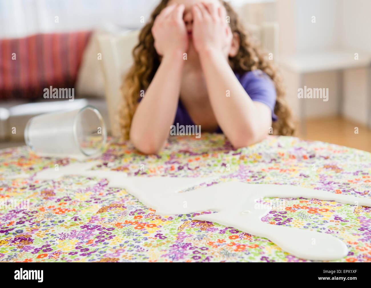 Sad girl (10-11) spilled out milk Stock Photo - Alamy