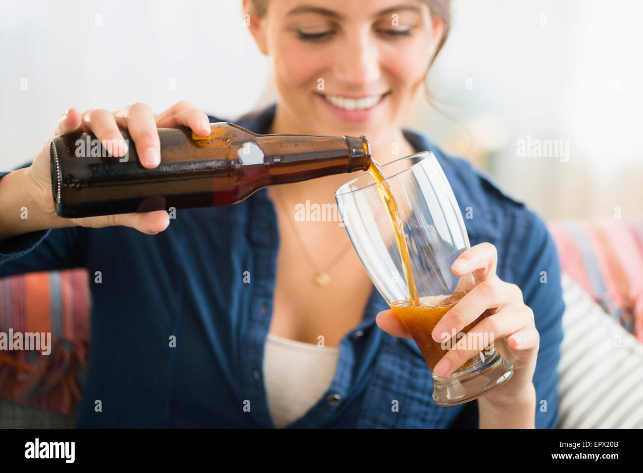 Woman pouring beer Stock Photo - Alamy