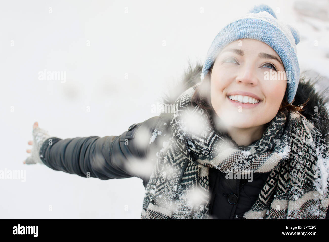 Portrait of smiling woman in snow Stock Photo - Alamy
