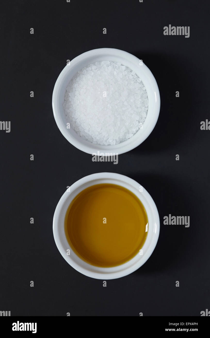 Olive oil and salt on black background Stock Photo - Alamy