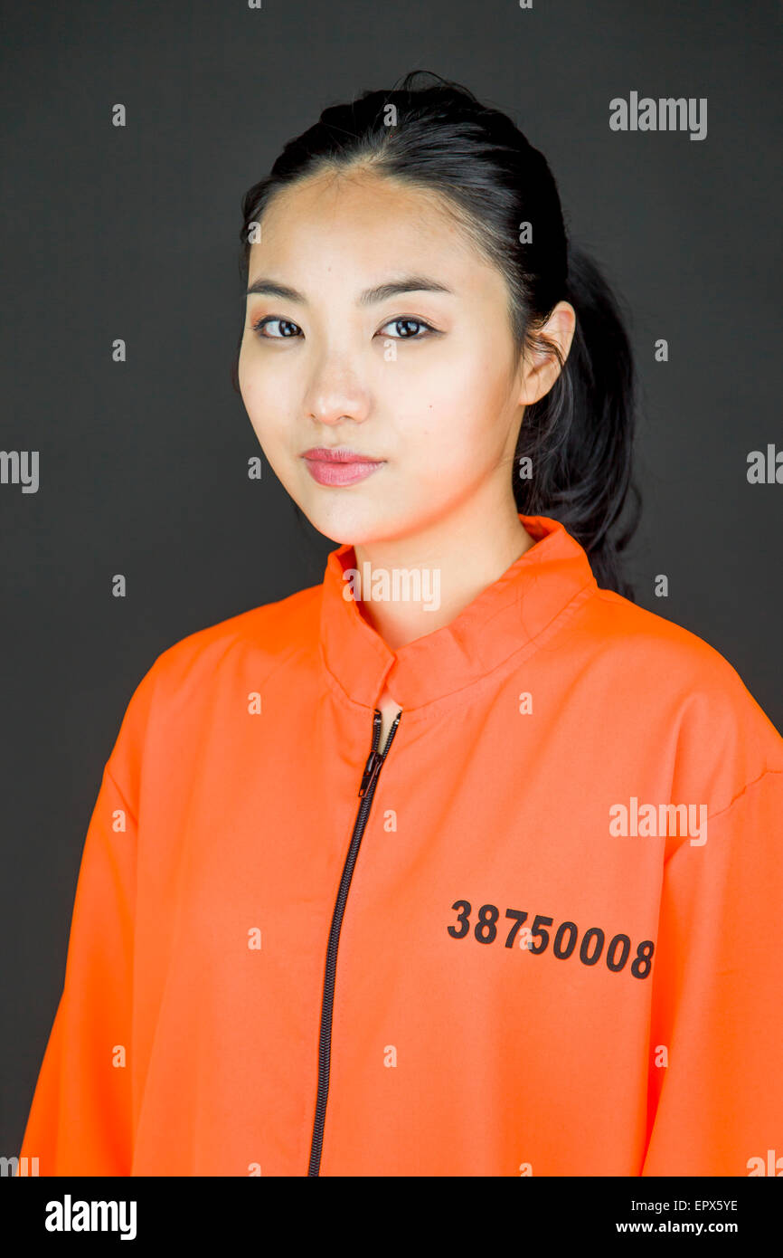 Portrait of a young Asian woman in prisoners uniform Stock Photo - Alamy