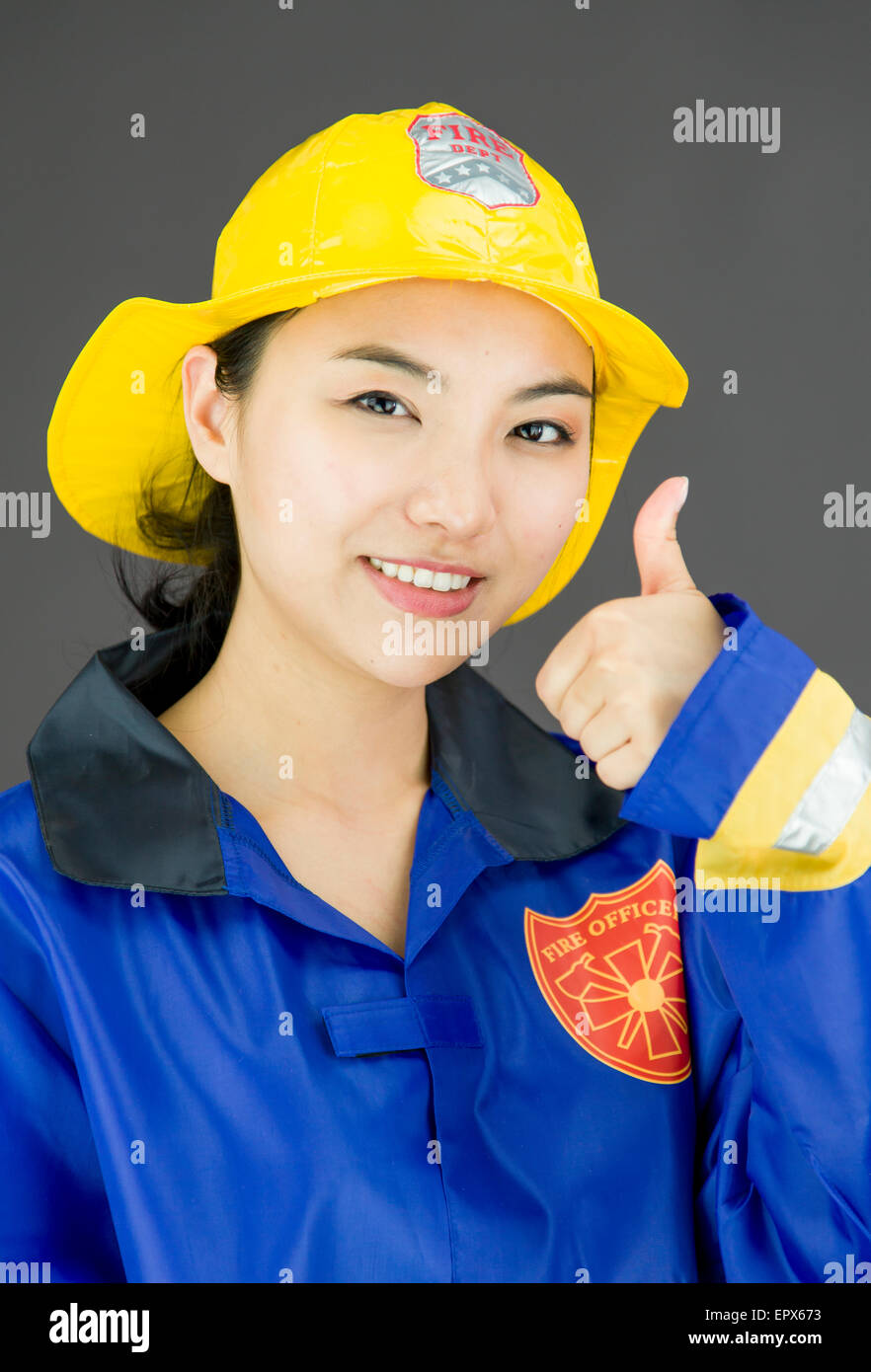 Close up of a lady firefighter showing thumbs up gesture Stock Photo ...