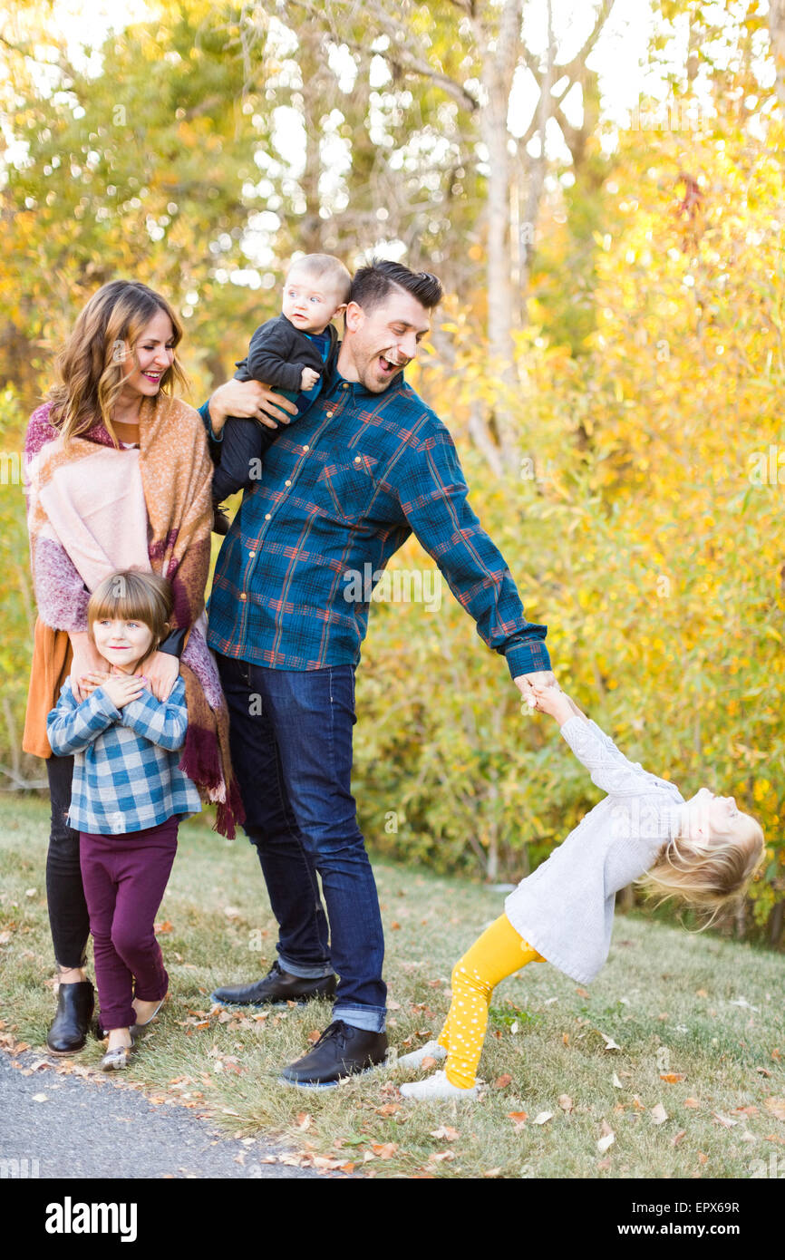Happy family with tree children (6-11 months, 2-3, 4-5) in park Stock ...