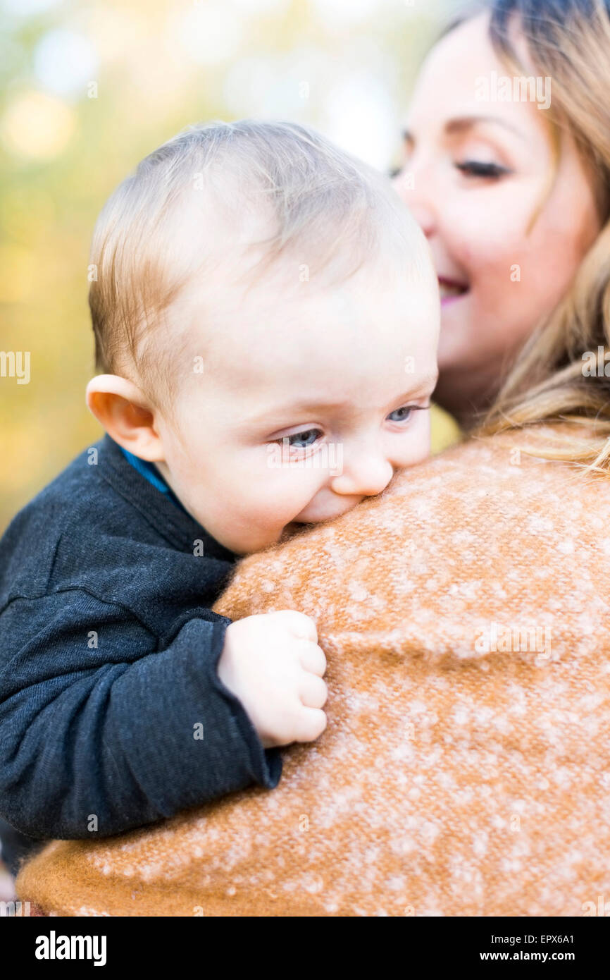 Mother carrying baby boy (6-11 months Stock Photo - Alamy