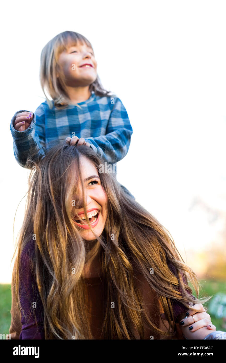 Young woman carrying girl (4-5) on shoulders Stock Photo - Alamy