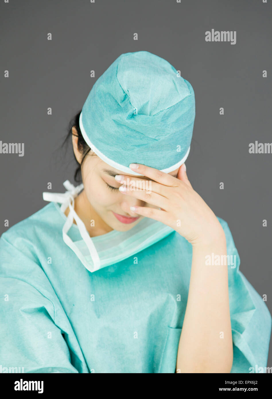 Asian female surgeon hiding her face Stock Photo - Alamy