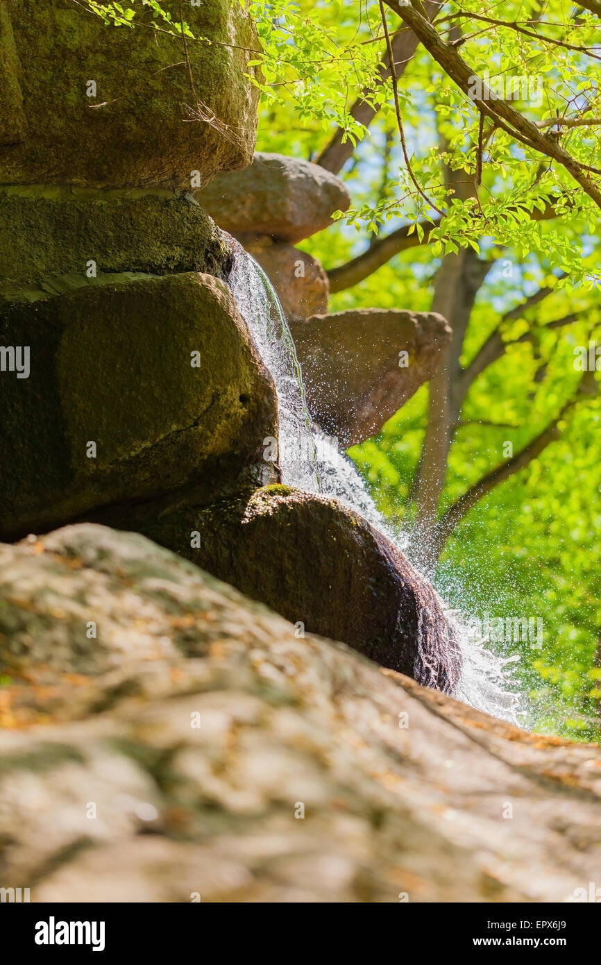stream of water flowing along the a rock Stock Photo - Alamy
