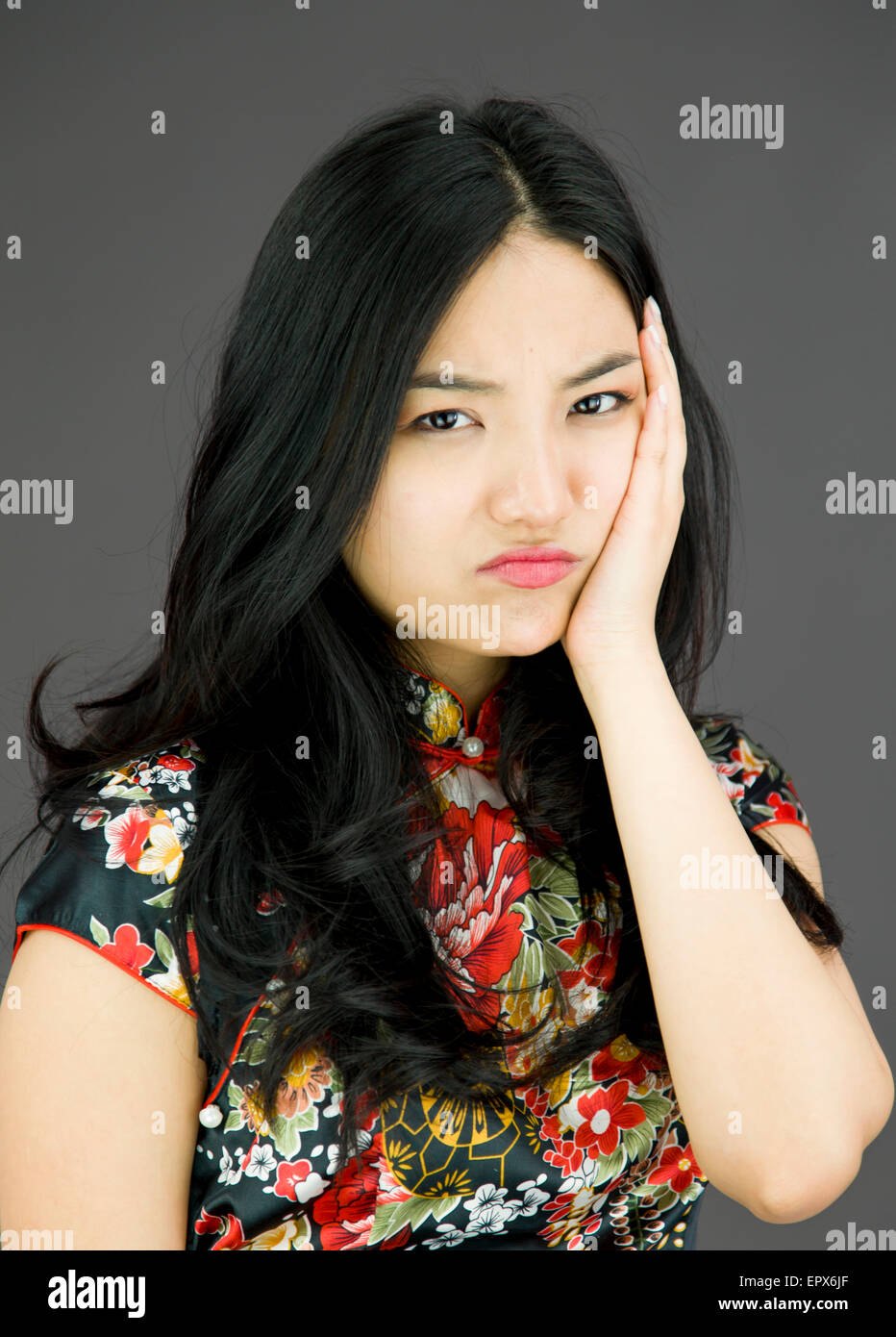 Asian young woman looking bored Stock Photo - Alamy