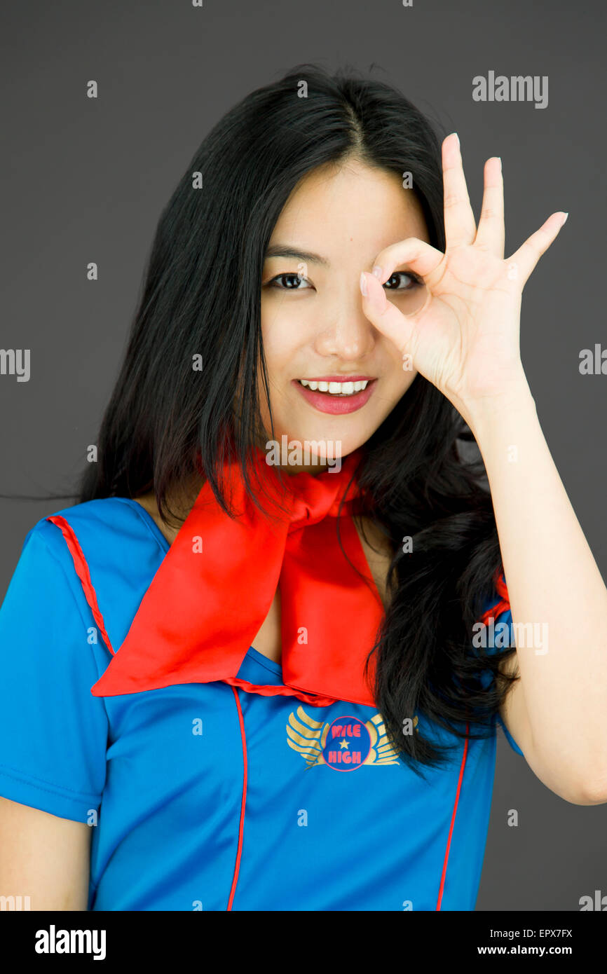 Asian air stewardess showing ok sign Stock Photo - Alamy