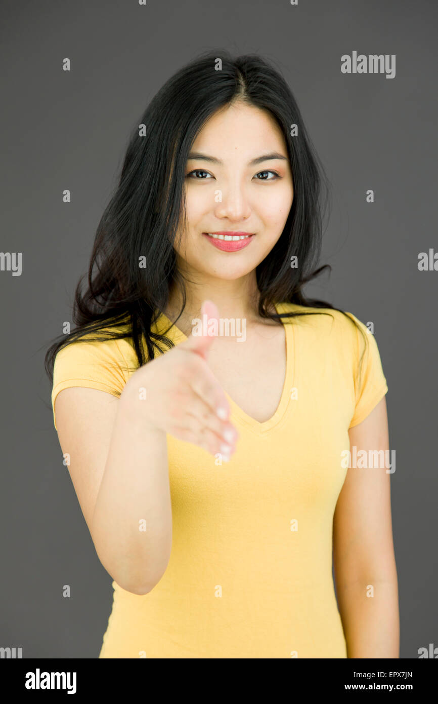 Young Asian woman offering hand for handshake Stock Photo - Alamy