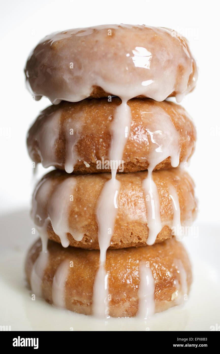 Stack of donuts with fresh glaze, white background Stock Photo - Alamy