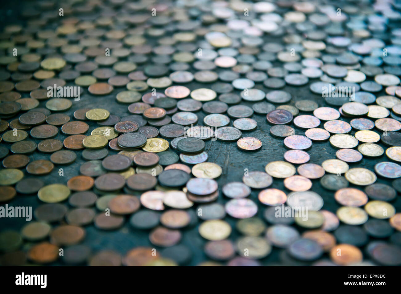 Thai coins left for good luck at Buddhist temple in Bangkok Thailand ...