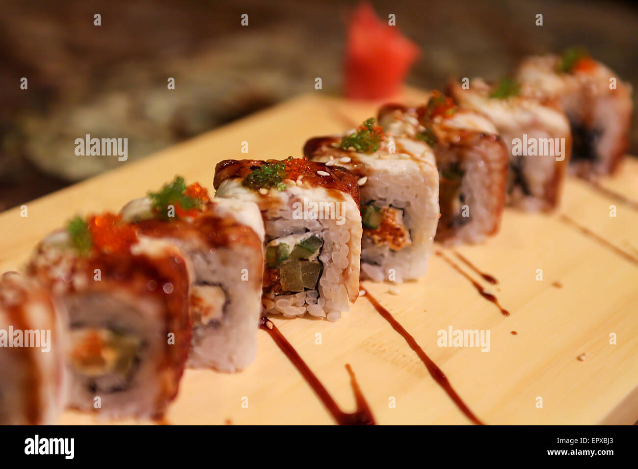 Delicious Dragon maki sushi rolls served with a wood plate Stock Photo ...