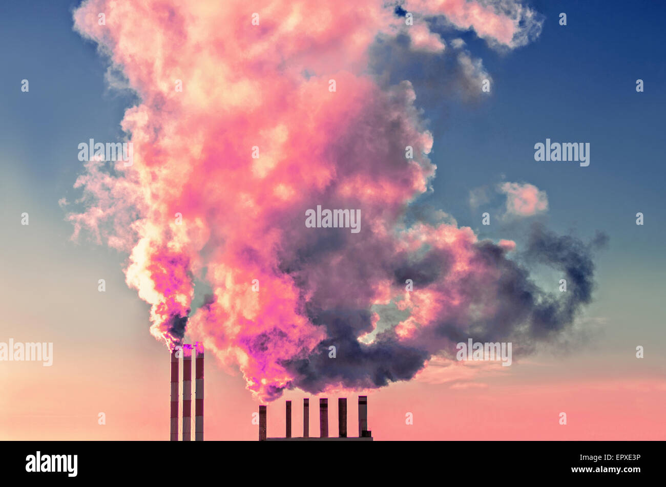 Chimney smoke at pink sunset sky Stock Photo - Alamy
