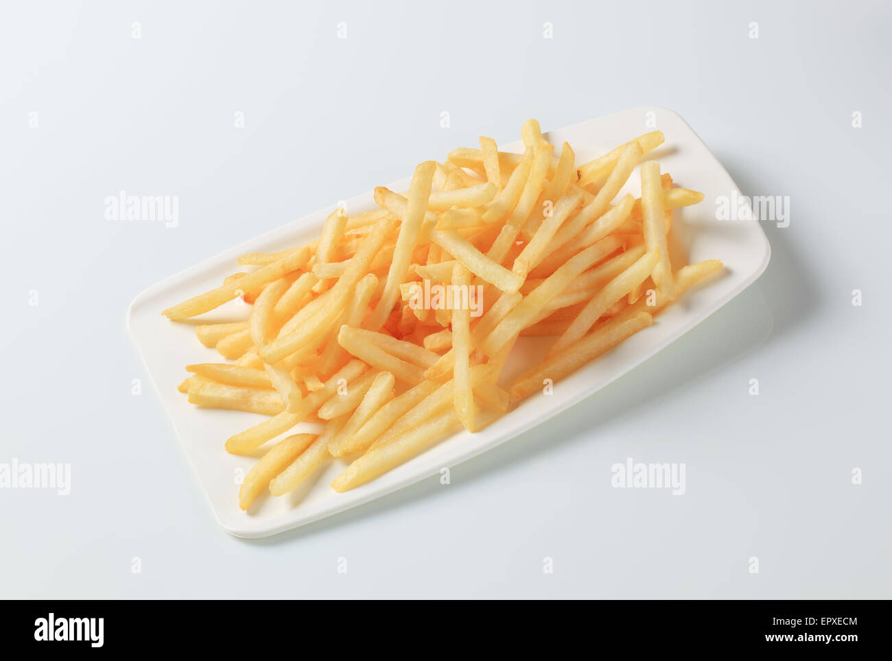 Portion of French fries on plastic plate Stock Photo - Alamy