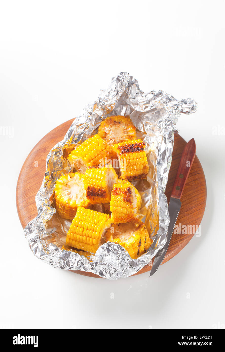 Pieces of grilled sweet corn in tin foil Stock Photo - Alamy