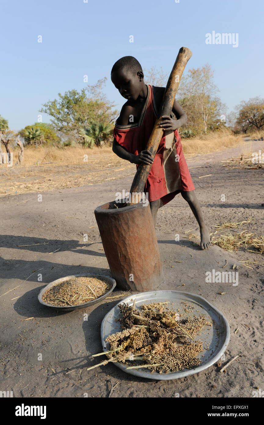 South Sudan Rumbek , Cuibet , Dinka boy prepares flour from Sorghum ...