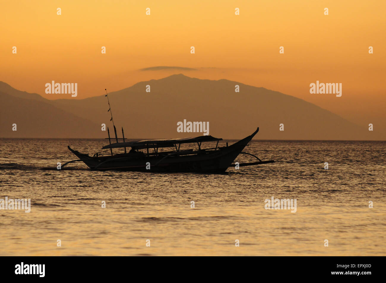 A Filipino tourist boat heading to the coast at the sunset. Mindoro ...