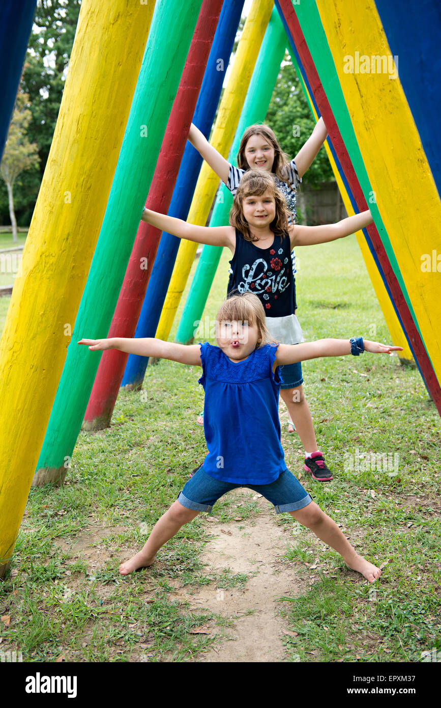 Children pose for fun family portrait at an outdoor park playground ...