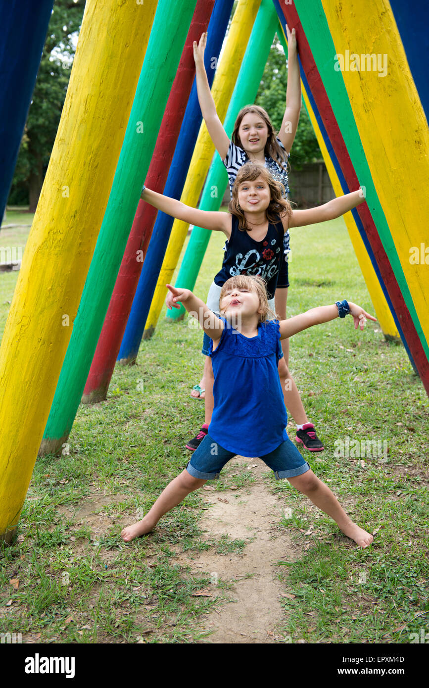 Children pose for fun family portrait at an outdoor park playground ...