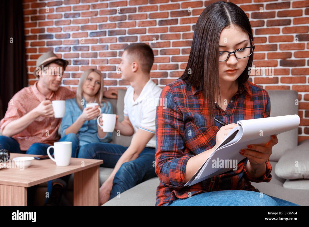 Girl writing her notebook in cafe Stock Photo - Alamy