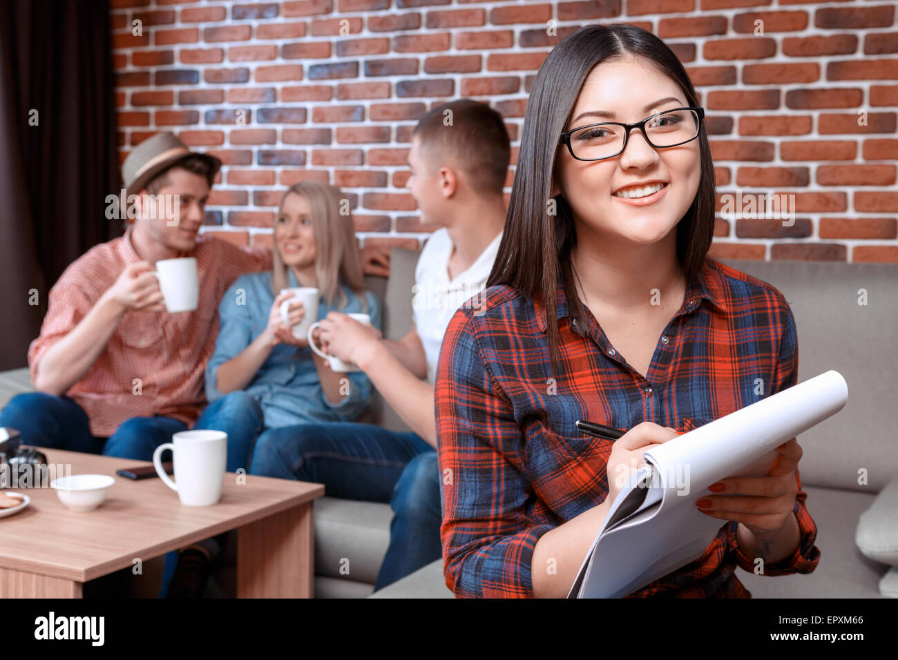 Girl writing her notebook in cafe Stock Photo - Alamy