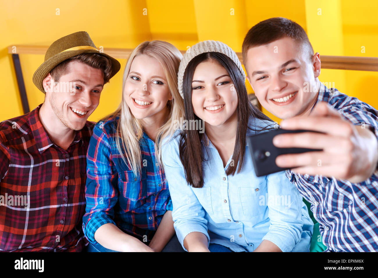 Happy friends making photos in a cafe Stock Photo - Alamy