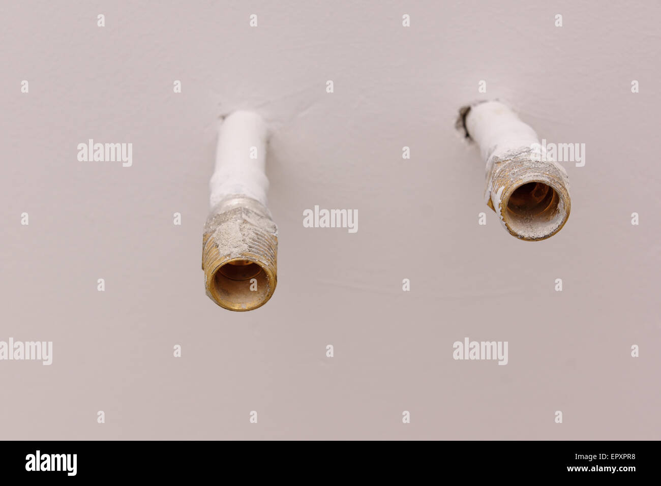 two pipes leave a wall for connection of bathroom equipment Stock Photo ...