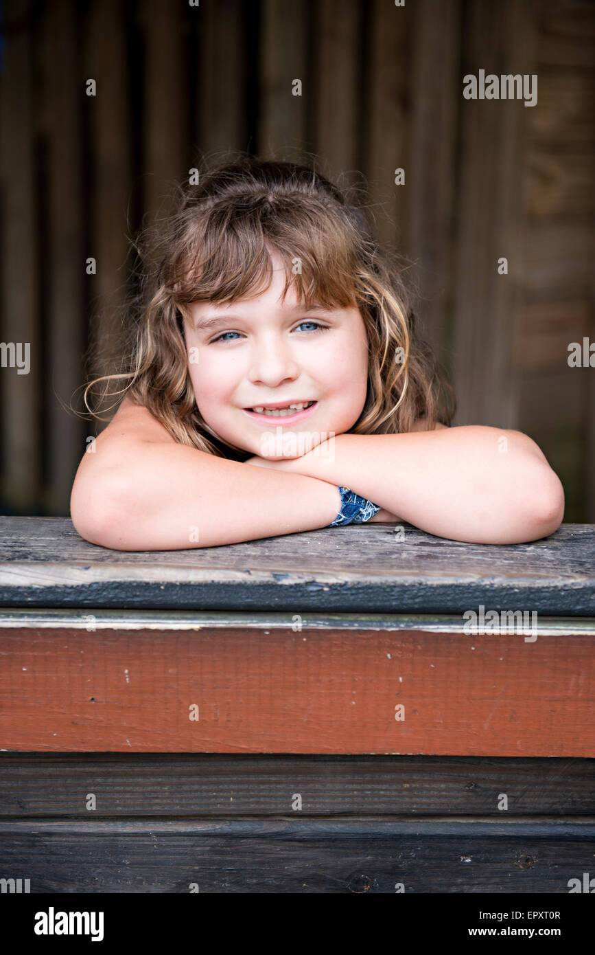 Young girl with her arms crossed posing for outdoor portrait Stock ...