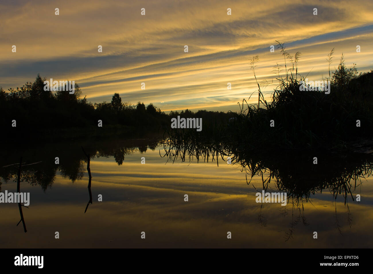 the sky is colored with different colors during sunrise over the river ...