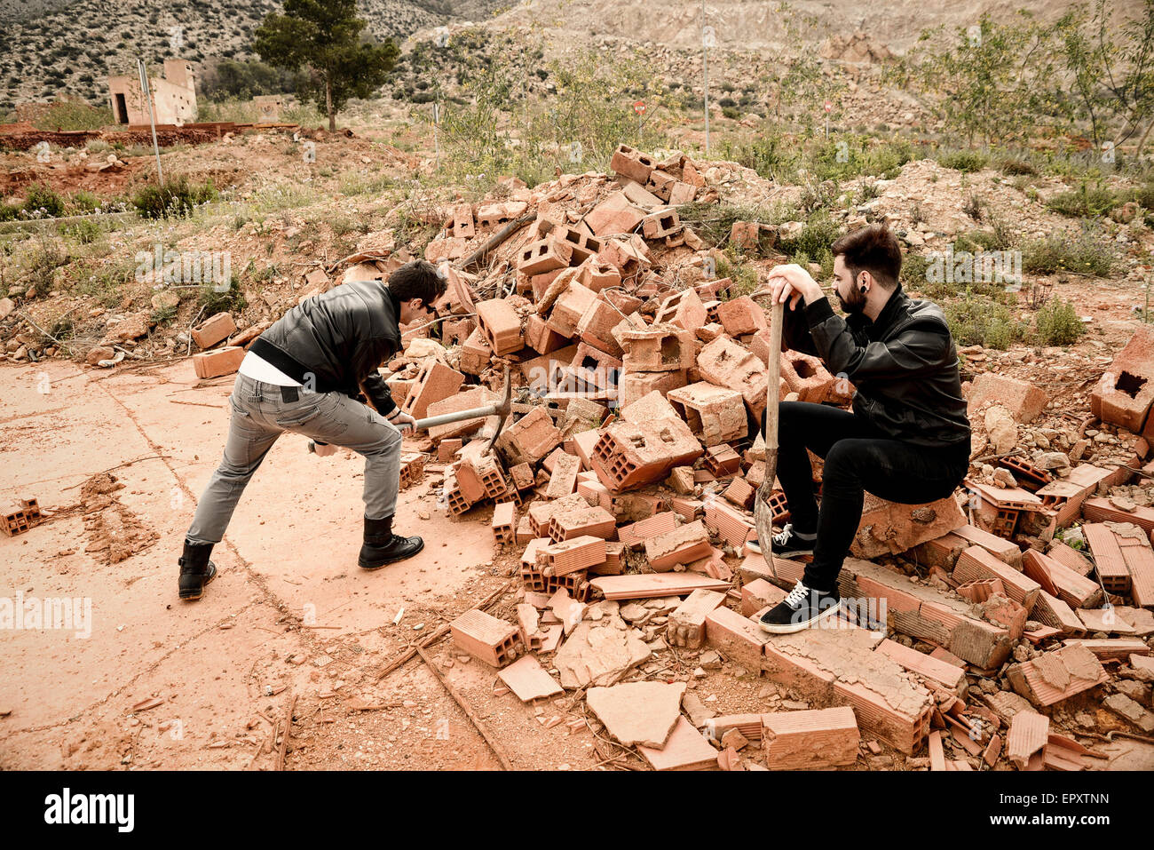 Guy working hard with a bystander doing nothing, a concept Stock Photo ...