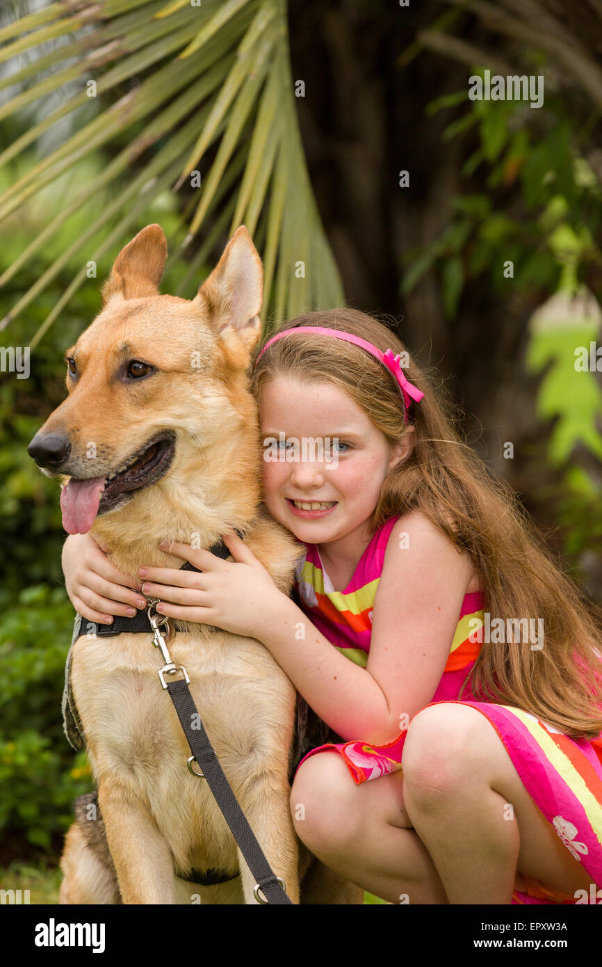 Rachel Mennet, a third-grader, poses with service dog Abel on September ...