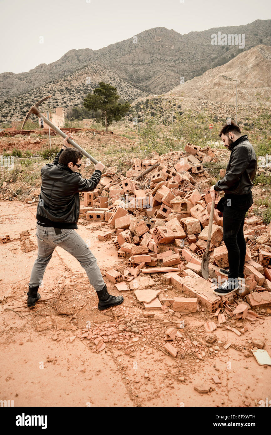 Guy working hard with a bystander doing nothing, a concept Stock Photo ...