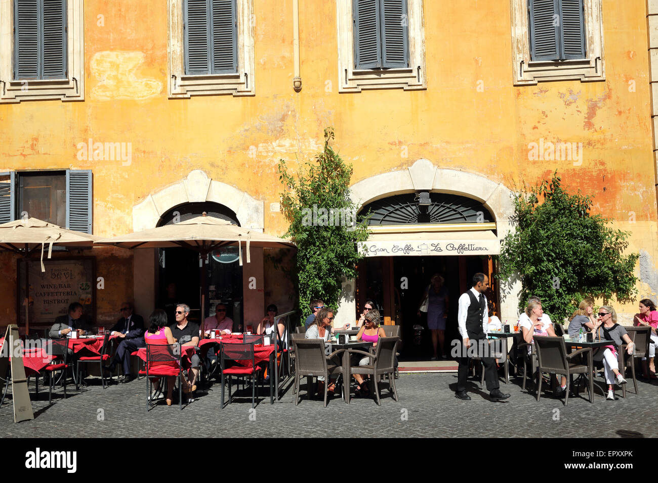 Outdoor dining area outside a cafe in Rome Stock Photo - Alamy