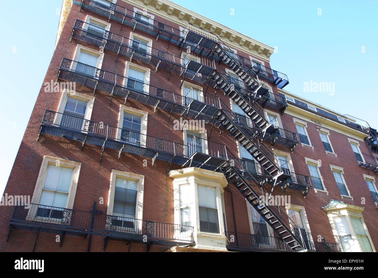 Old residential houses with fire escapes stairs in downtown Boston ...