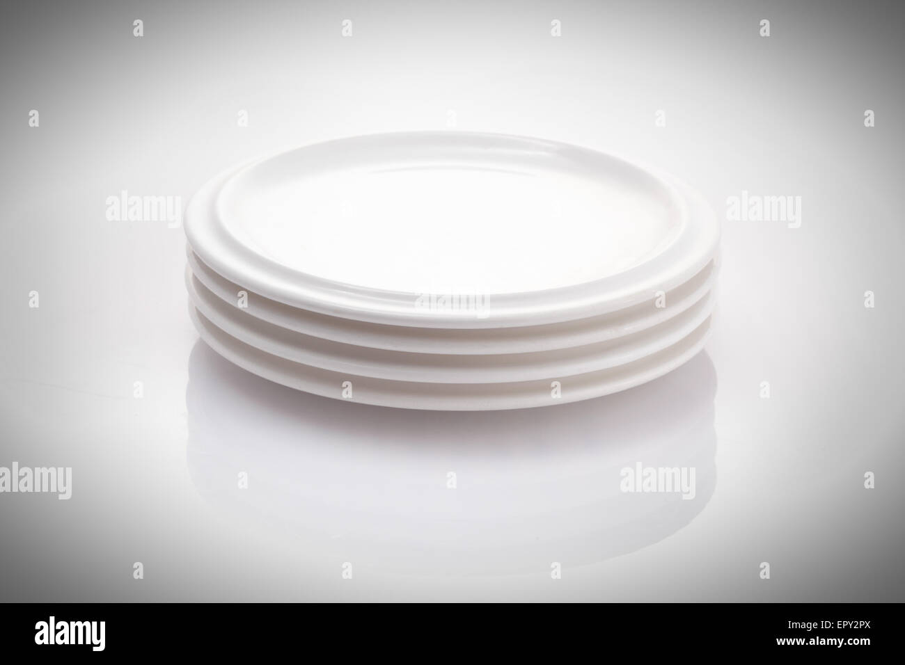 stack of plates isolated on a white background Stock Photo - Alamy