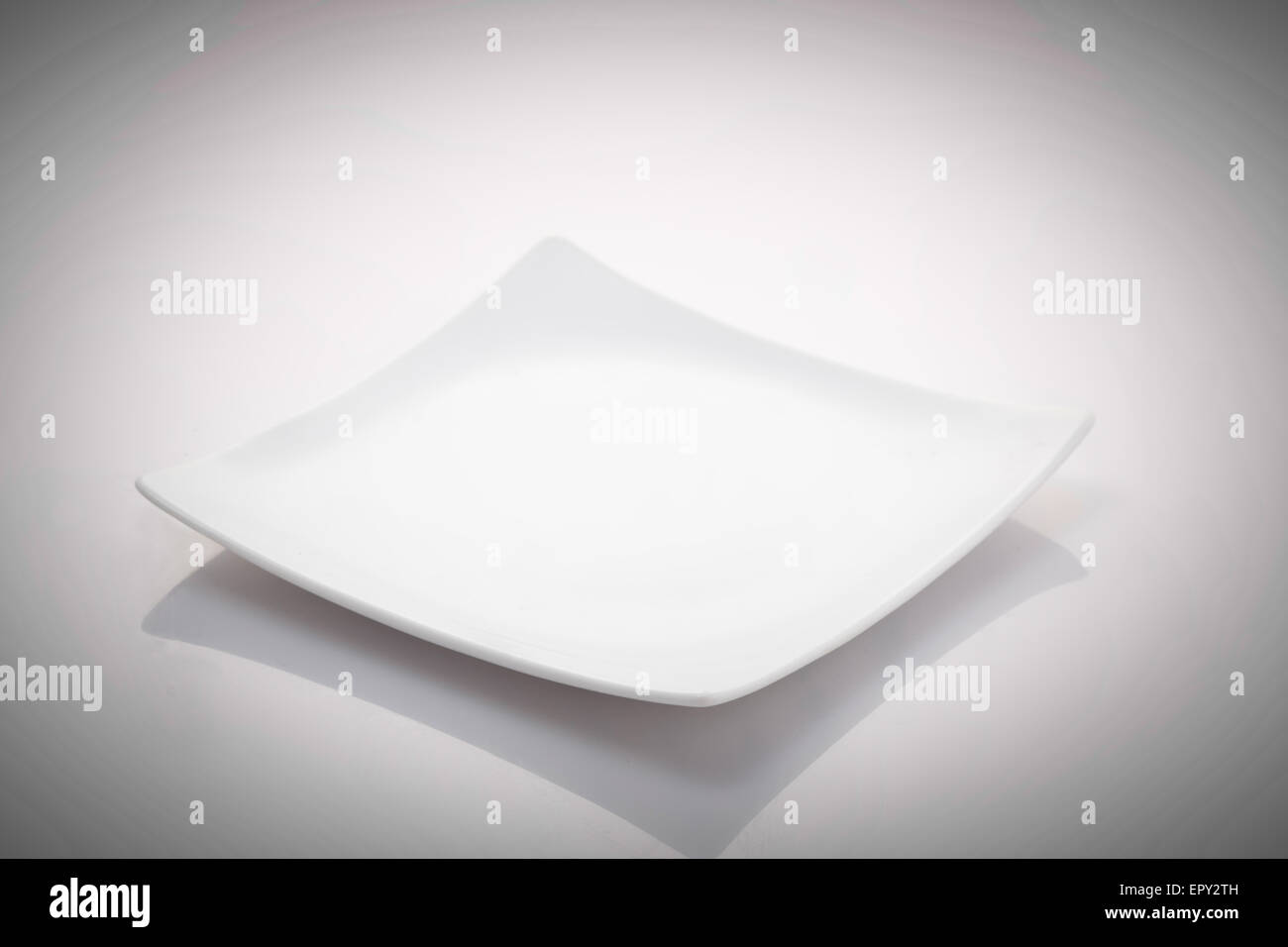 one empty square plate isolated on a white background Stock Photo - Alamy