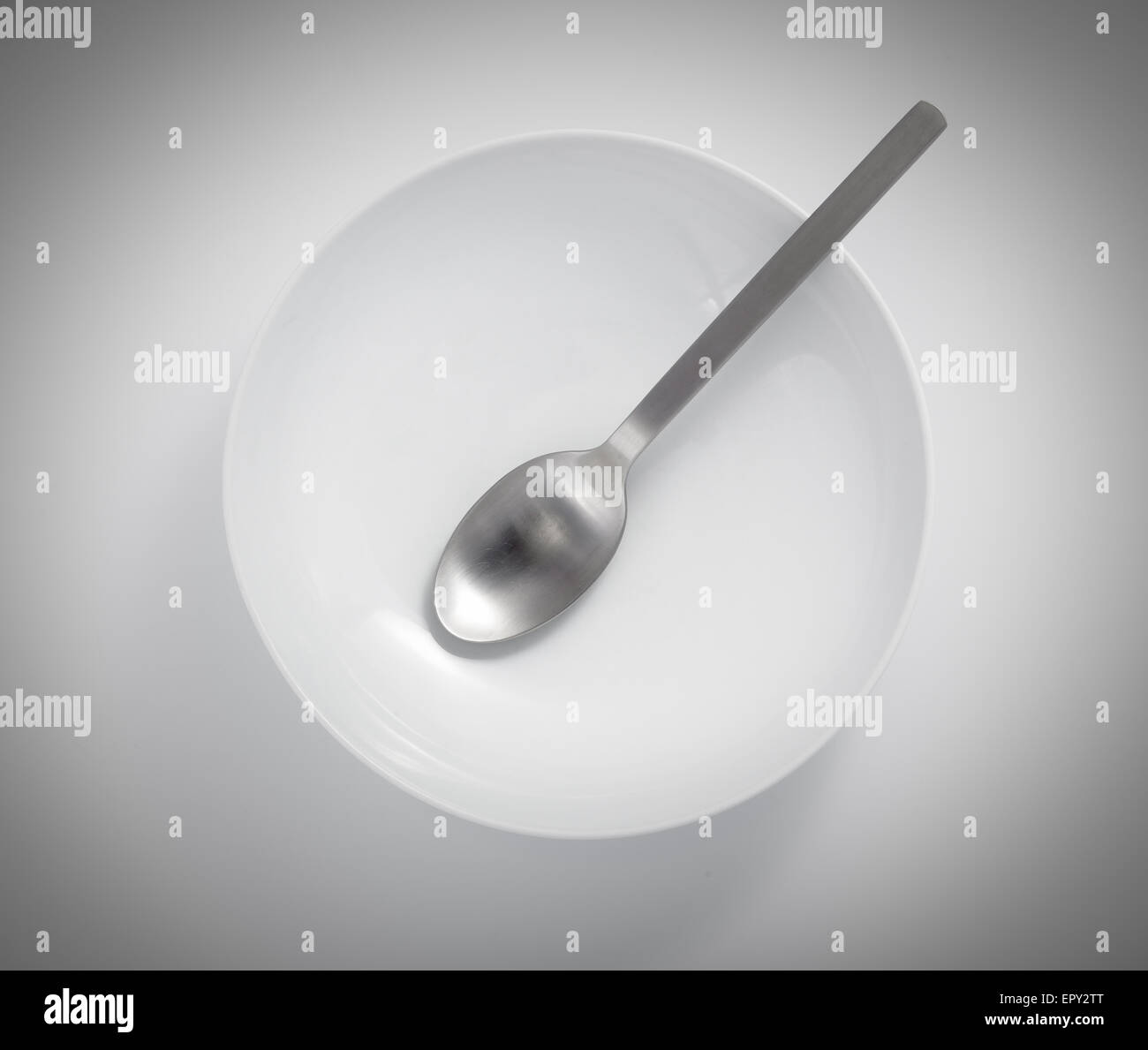 spoon in an empty bowl isolated on a white background Stock Photo - Alamy