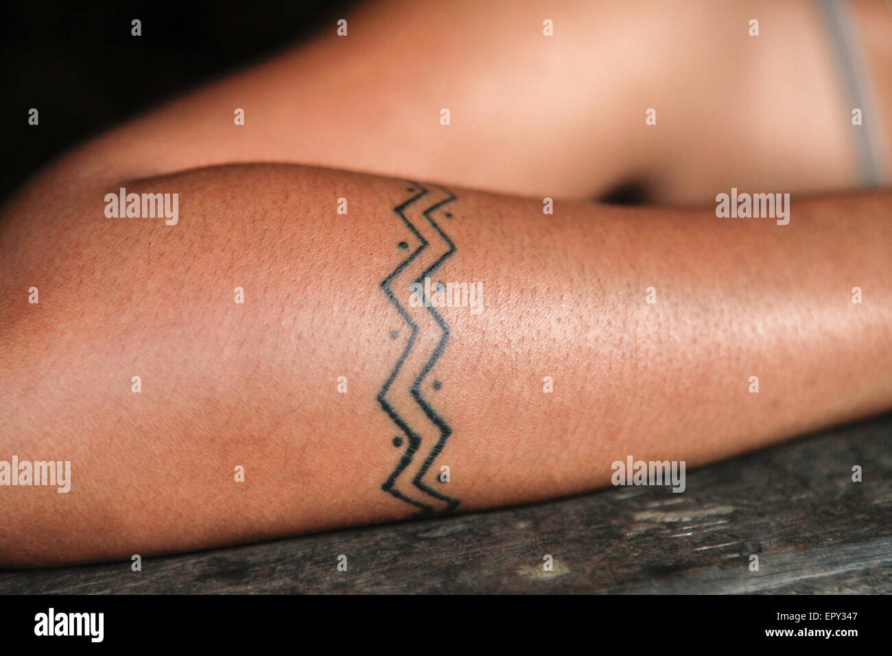 A woman showing her tattoo at the traditional longhouse of Dayak Iban ...