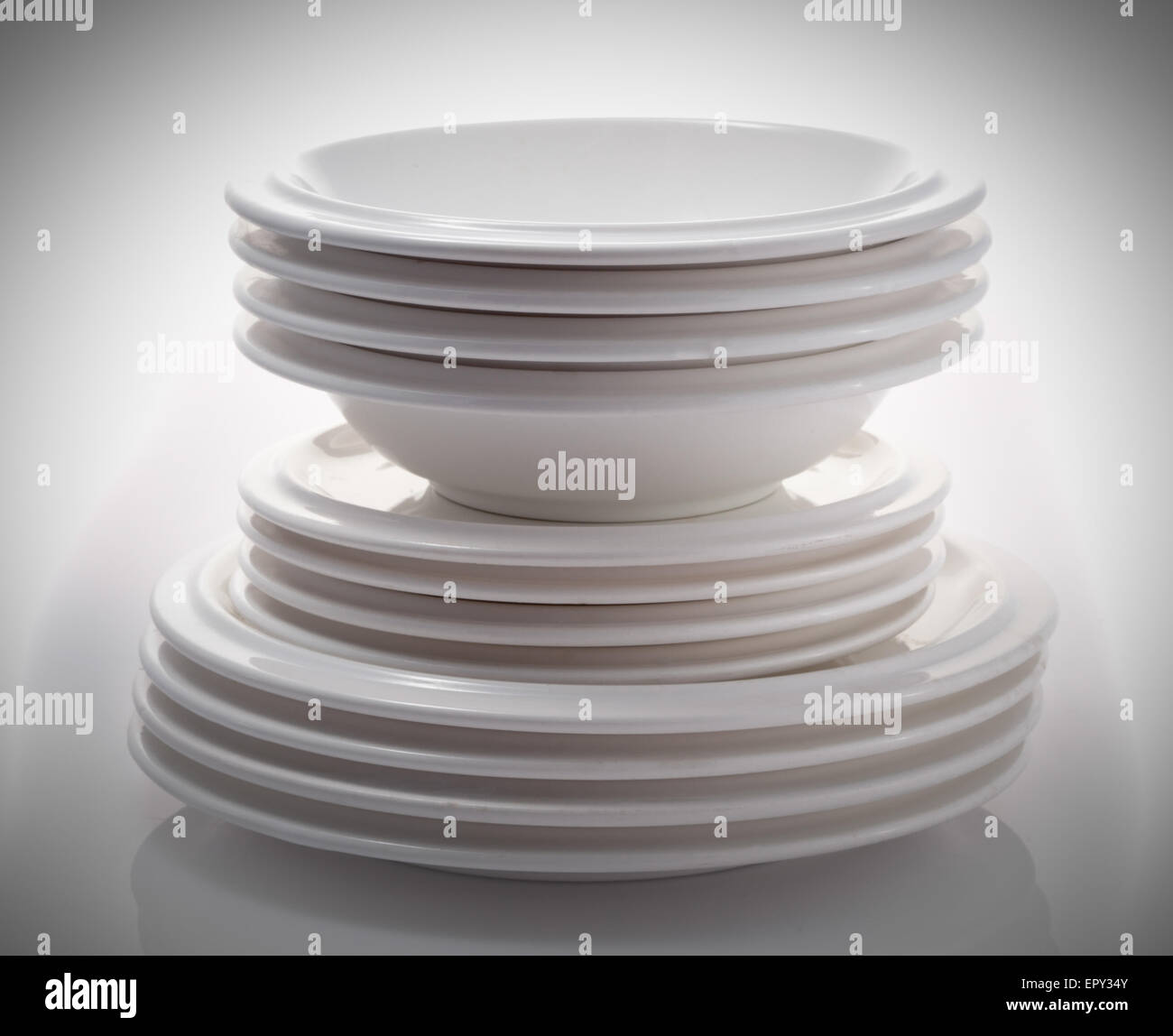 stacks of plates isolated on a white background Stock Photo - Alamy