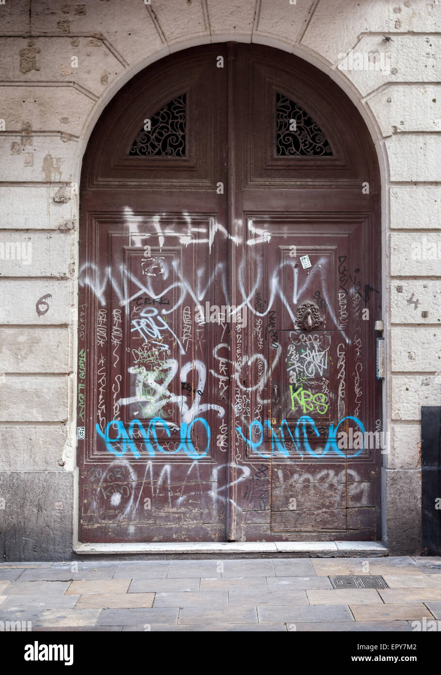 Graffiti on entrance gate of a building, Barcelona, Catalonia ...