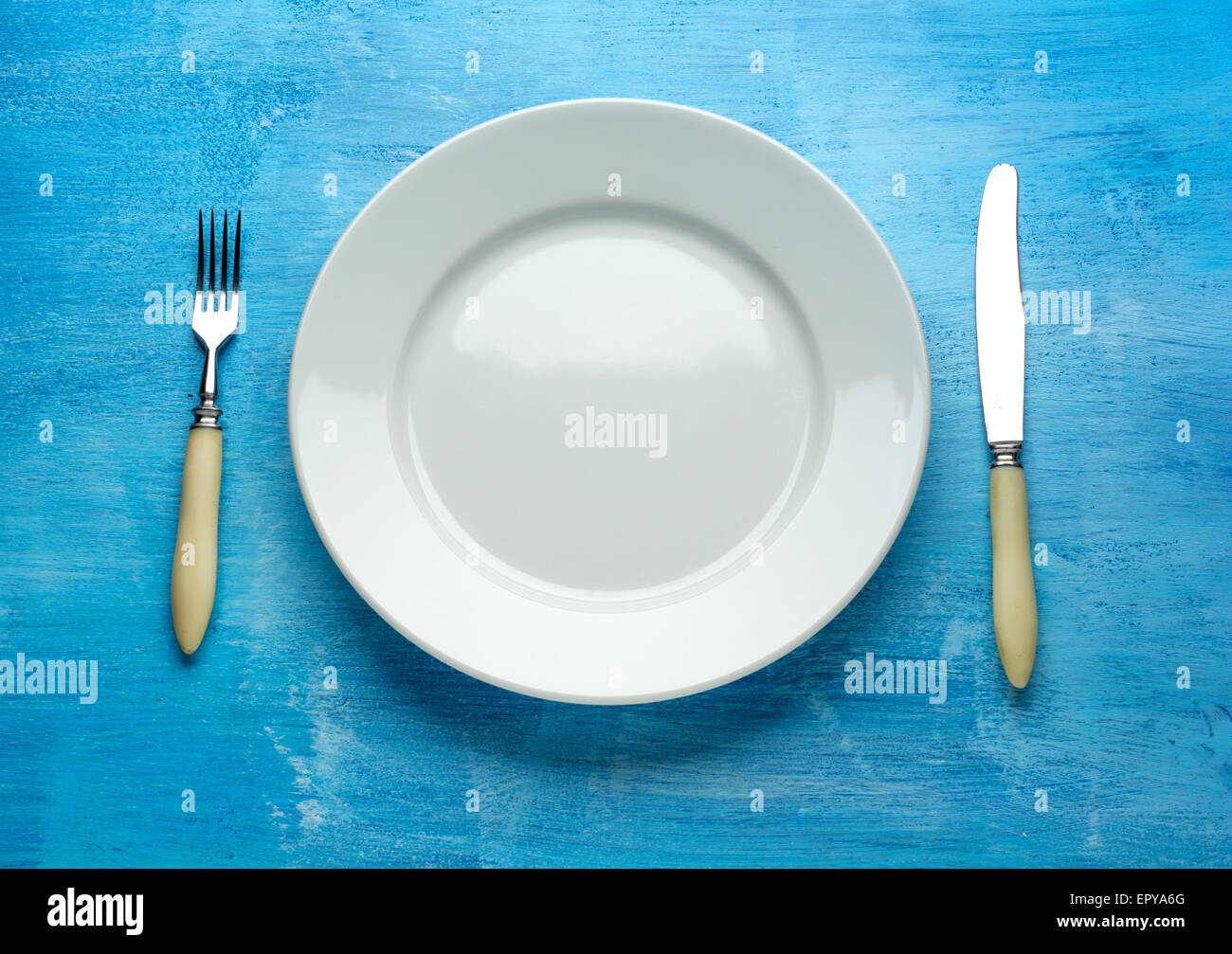 Plate fork knife blue background hi-res stock photography and images ...