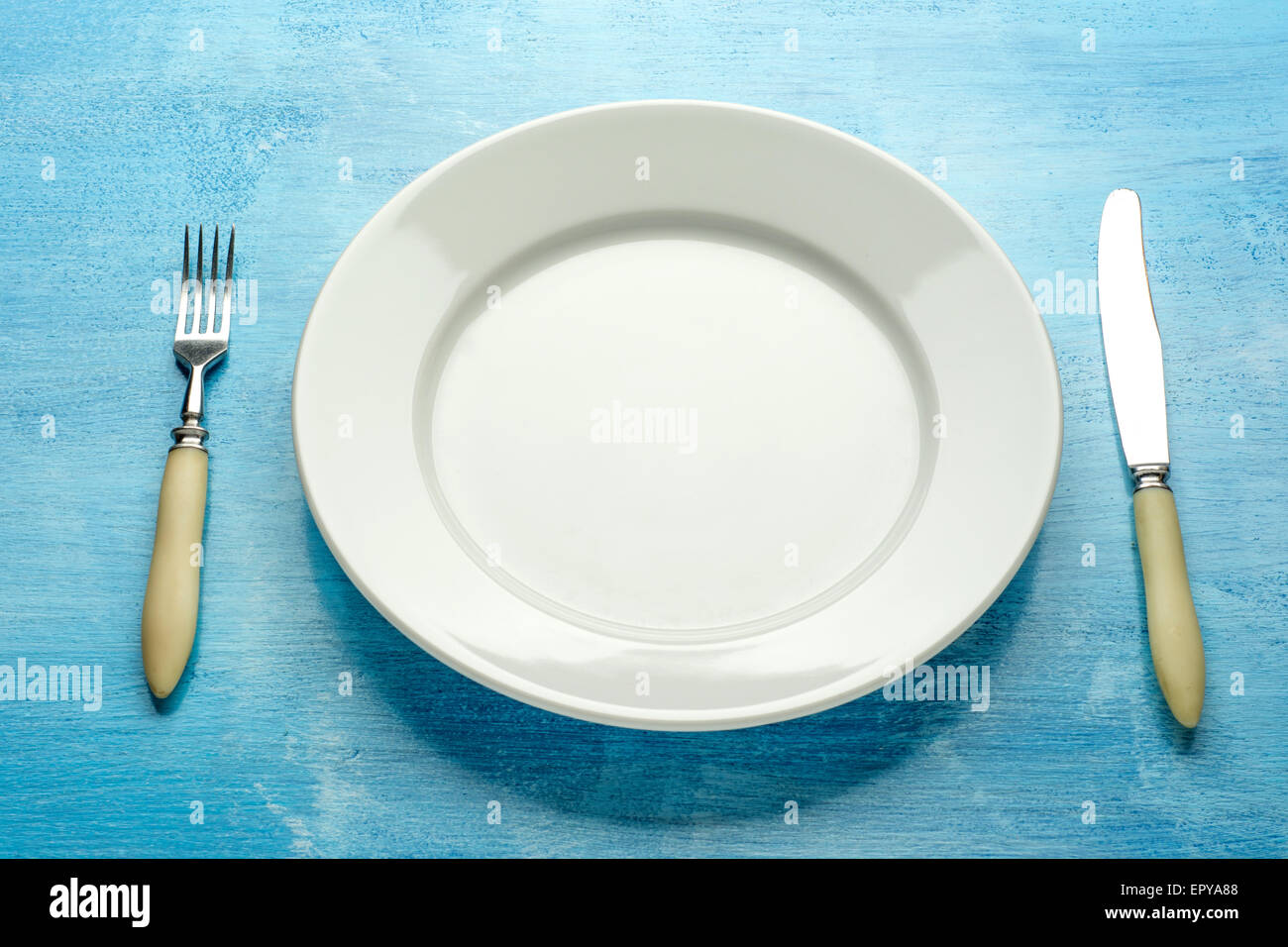 Plate fork knife blue background hi-res stock photography and images ...