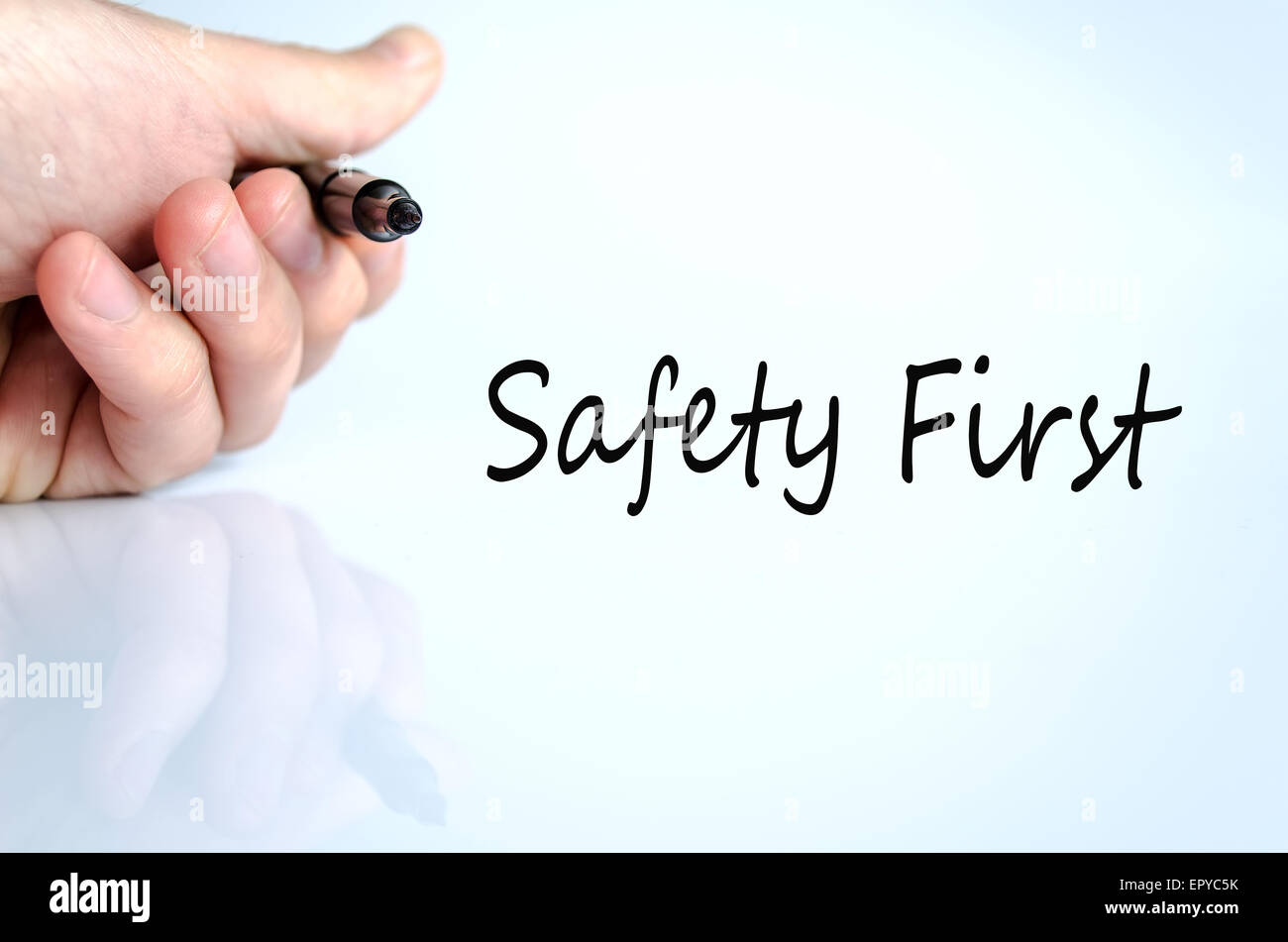 Pen in the hand isolated over white background Safety First concept ...