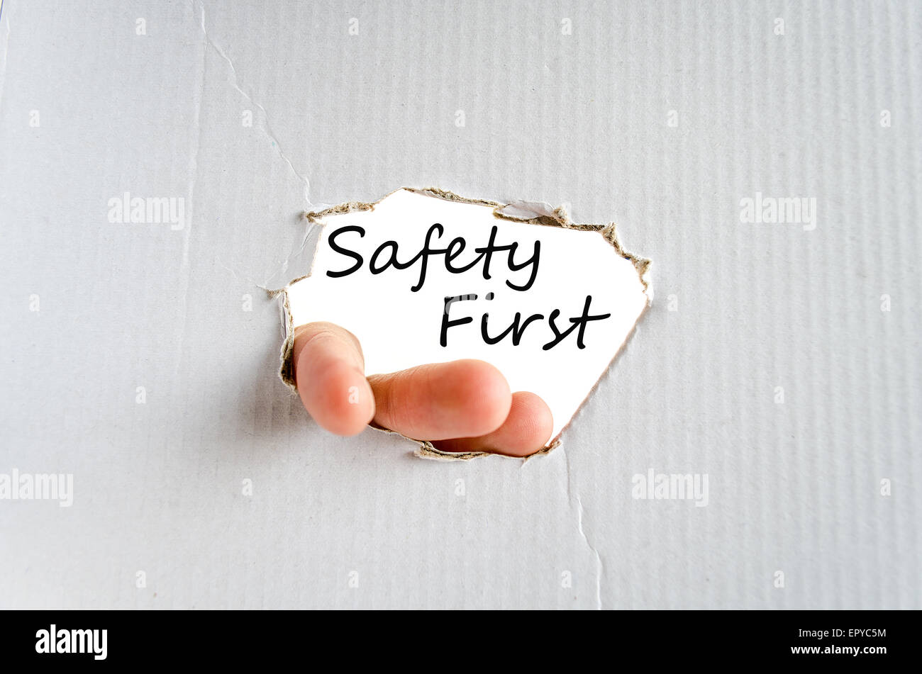 Hand and text on the cardboard background Safety First concept Stock ...