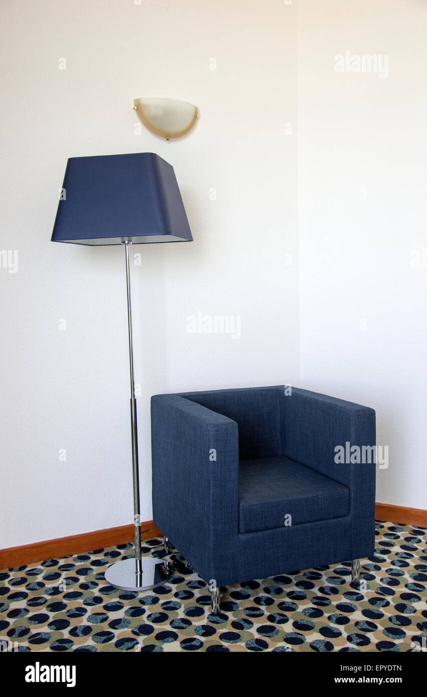 Floor lamp with a blue shade and matching chair Modern furniture Stock ...
