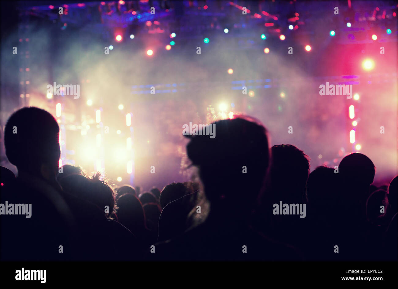 Cheering crowd in front of bright colorful stage lights - retro styled ...