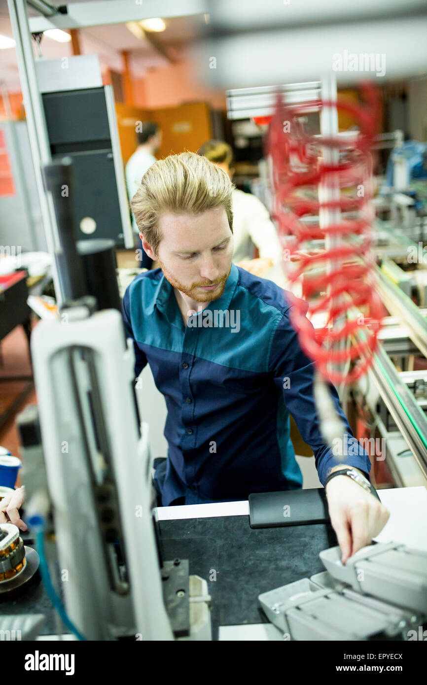 Young man in electronics workshop Stock Photo - Alamy