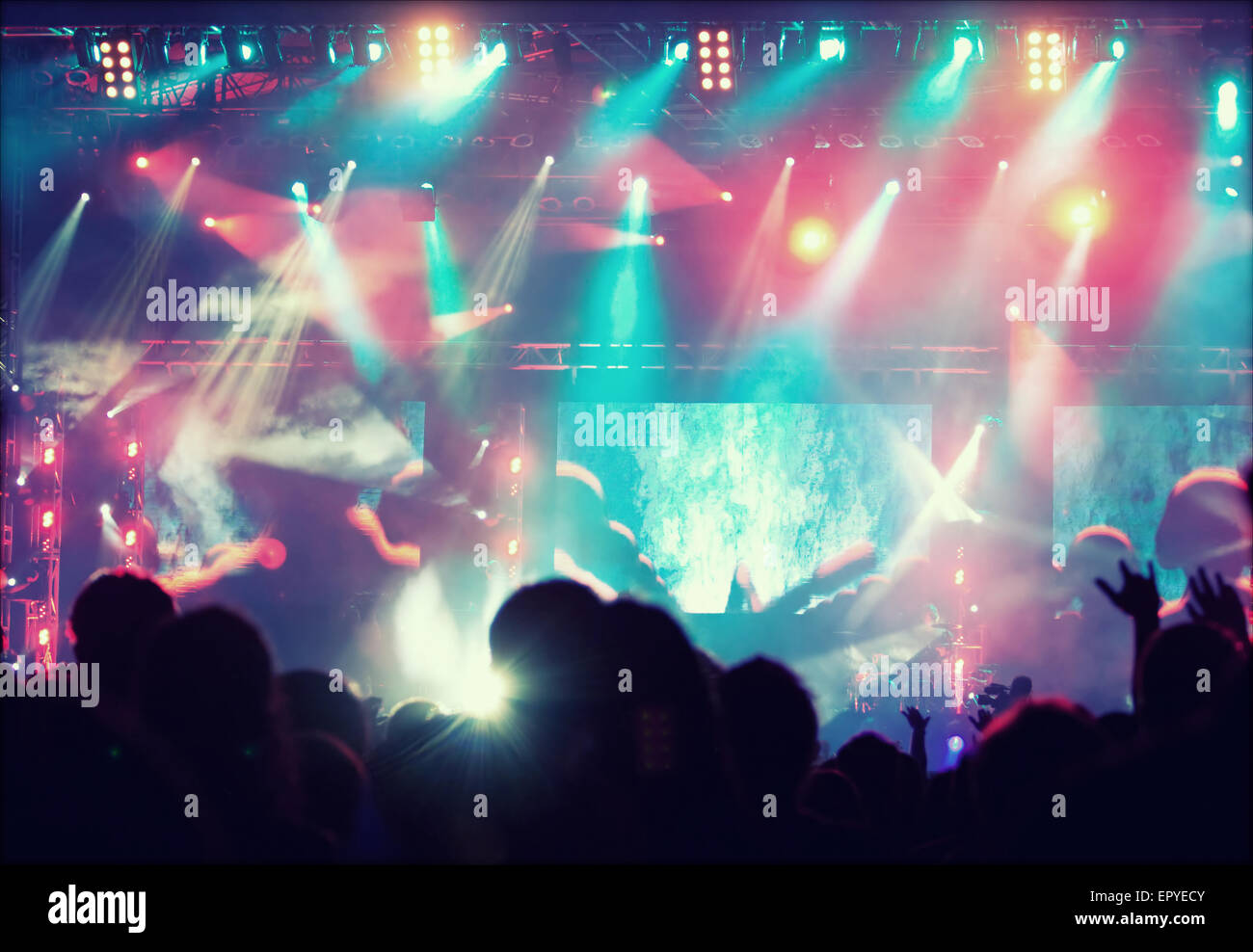 Cheering crowd in front of bright colorful stage lights - retro styled ...