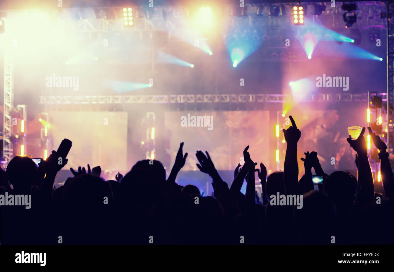 Cheering crowd in front of bright colorful stage lights - retro styled ...